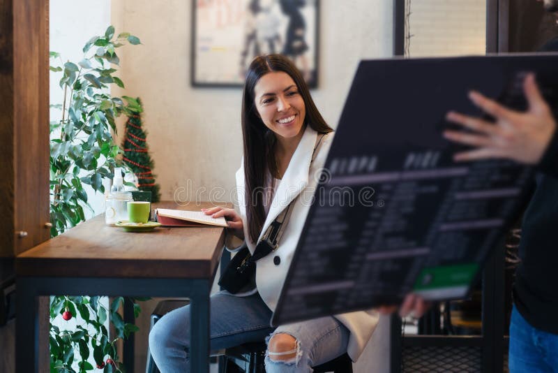 Beautiful Woman Ordering from Menu in Restaurant Stock Photo - Image of ...
