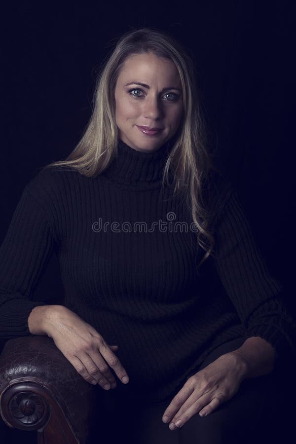 Beautiful Woman Portrait In Low Light Sitting On Brown Leather S Stock