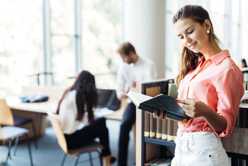 Beautiful Woman Reading a Book in a Library Stock Photo - Image of ...