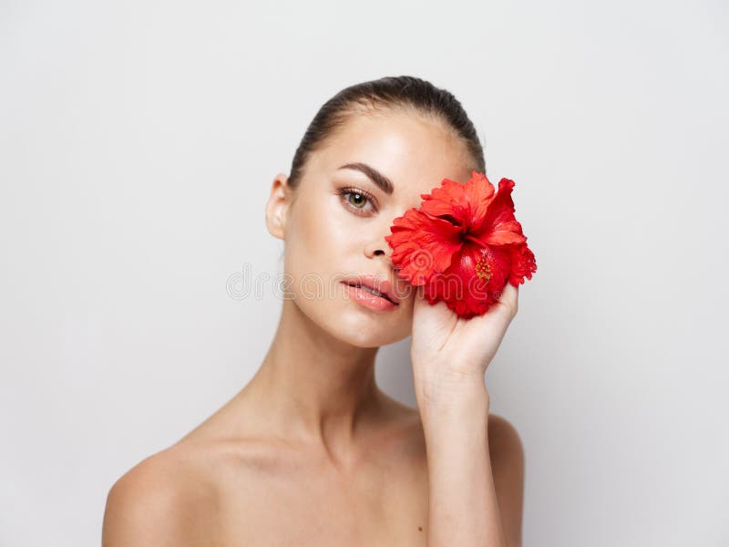 Beautiful Woman With Red Flower Near Face Clear Skin Bare Shoulders