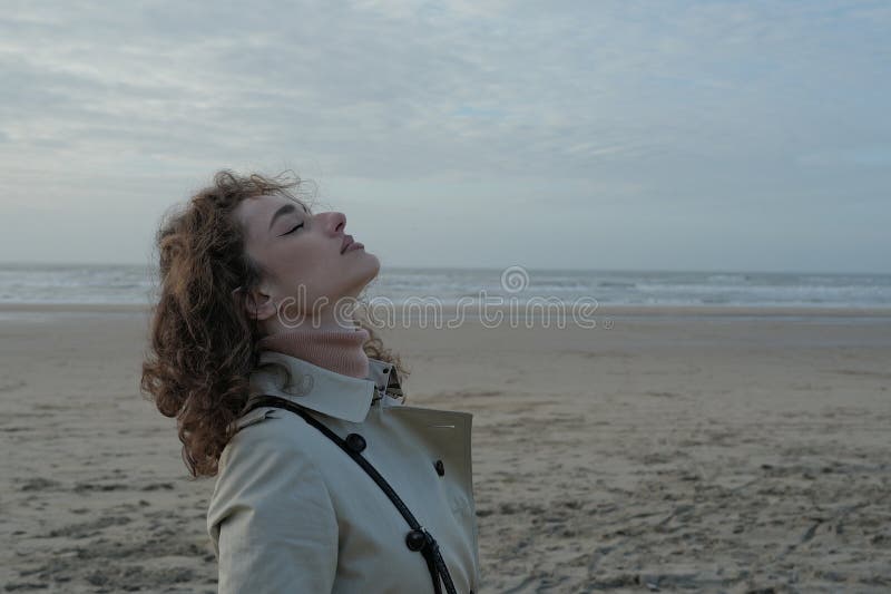 Beautiful Woman Relaxing on the Beach Taking a Deep Breath Stock Photo ...