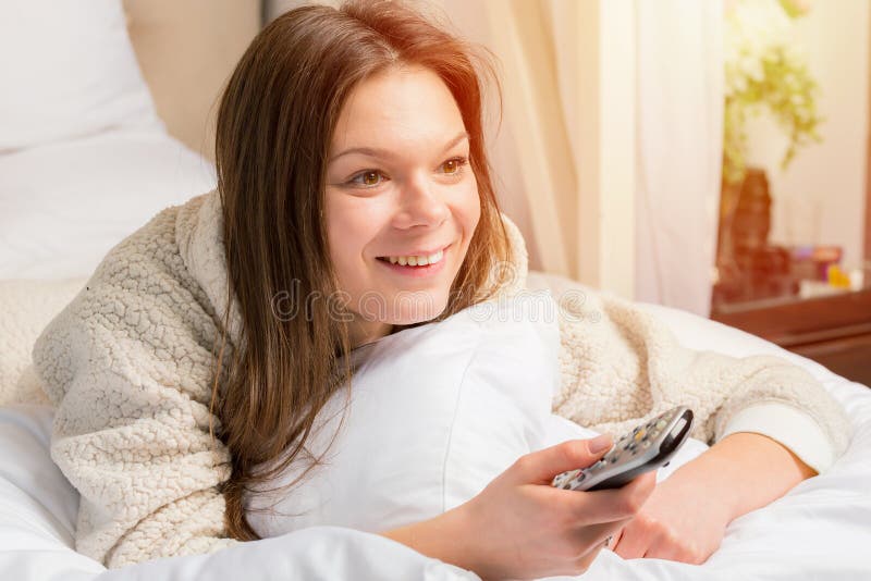 Beautiful Woman with Remote Control in Bed Stock Image - Image of ...