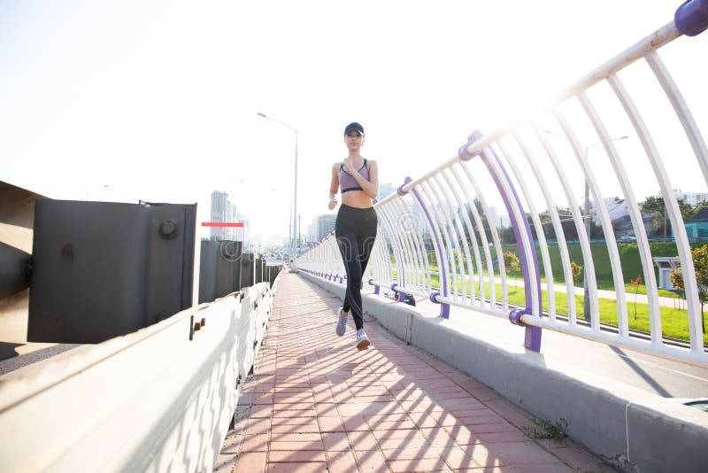 Beautiful Woman Running Over Bridge during Sunset. Stock Image - Image ...