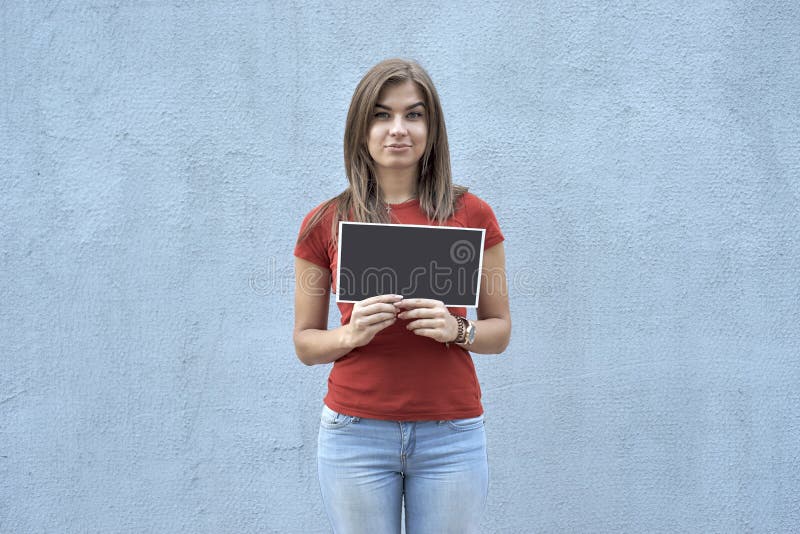 Beautiful Woman with a Sign on the Background of a Concrete Wall Stock ...