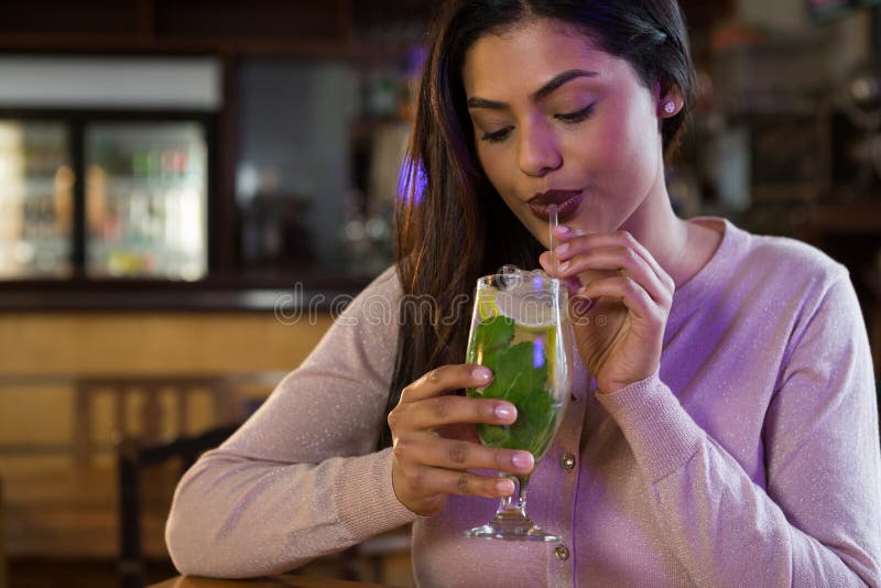 Woman sipping on a drink stock image. Image of lime - 102566903