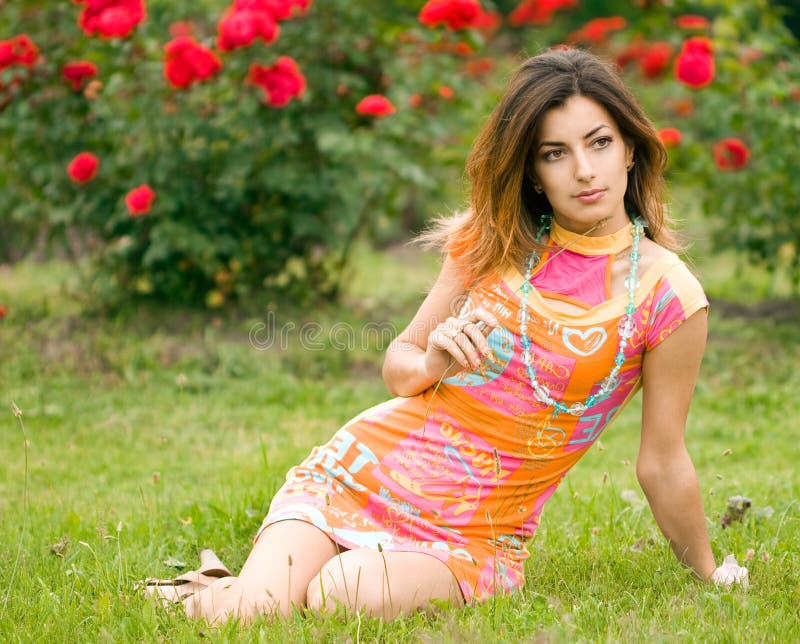 Beautiful Woman Sits on a Grass Stock Image - Image of horticulture ...