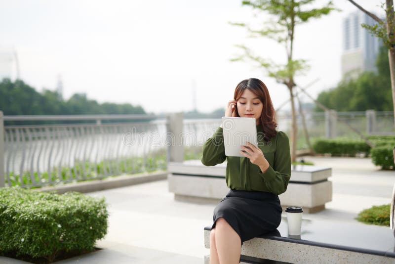 Beautiful Woman Sitting on Bench Using Tablet Outdoor Stock Image ...