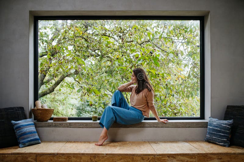 Beautiful Woman Sitting in Front of Large Window, Clean Space. Stock ...