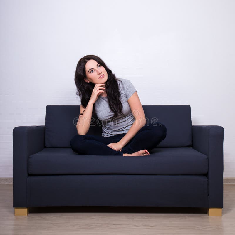 Beautiful Woman Sitting on Sofa and Thinking about Something Stock ...