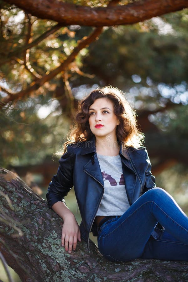 Beautiful Woman Sitting on a Tree Stock Photo - Image of girl, sitting ...