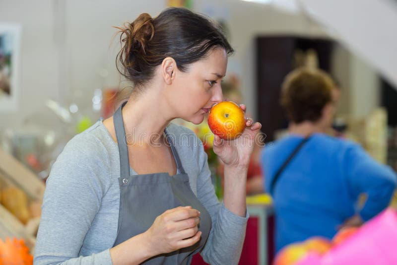Beautiful Woman Smelling Apple Stock Photo - Image of seller, concept ...