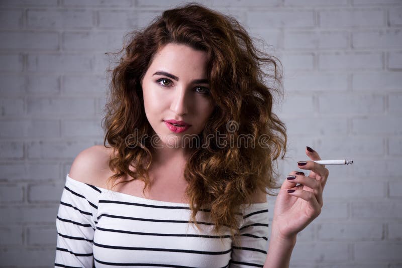 Beautiful Woman Smoking Cigarette Over White Brick Wall Stock Photo ...