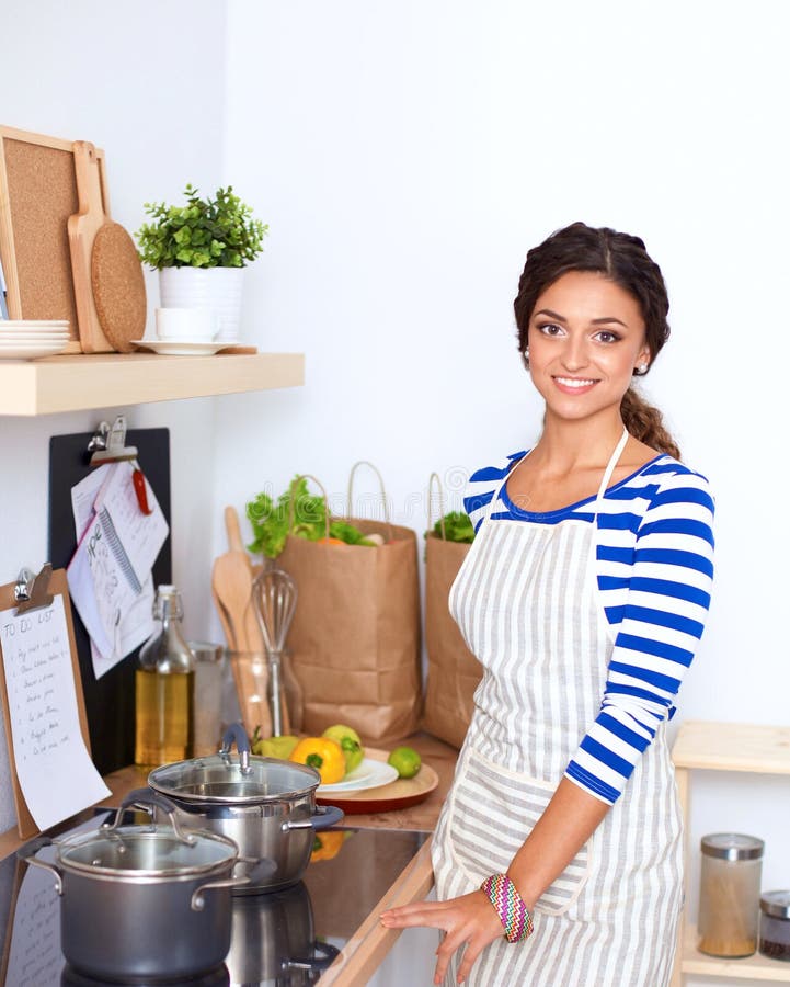Beautiful Woman Standing in Kitchen with Apron Stock Photo - Image of ...