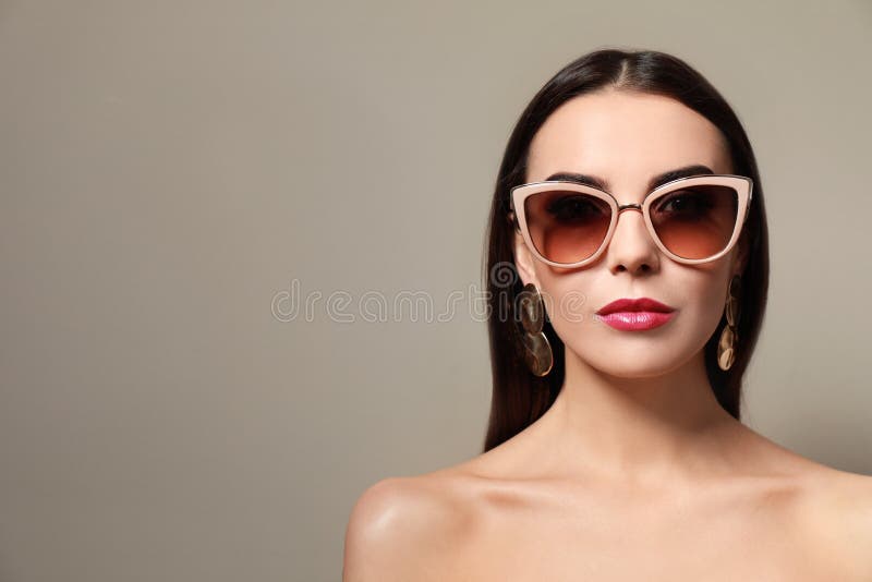 Beautiful Woman In Stylish Sunglasses On Background Space For Text