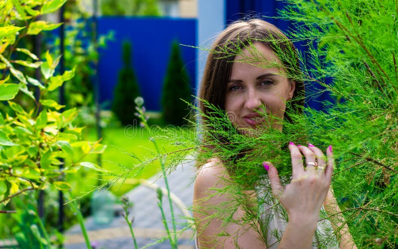 A Beautiful Woman in the Summer in a Lush Garden. Stock Image - Image ...