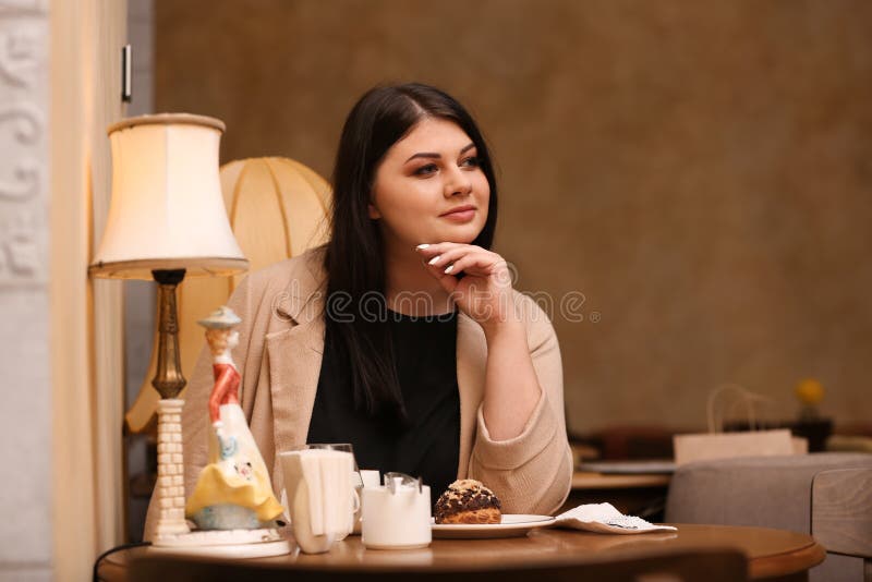 Beautiful Woman At Table In Cafe. Plus Size Model Stock Image - Image ...