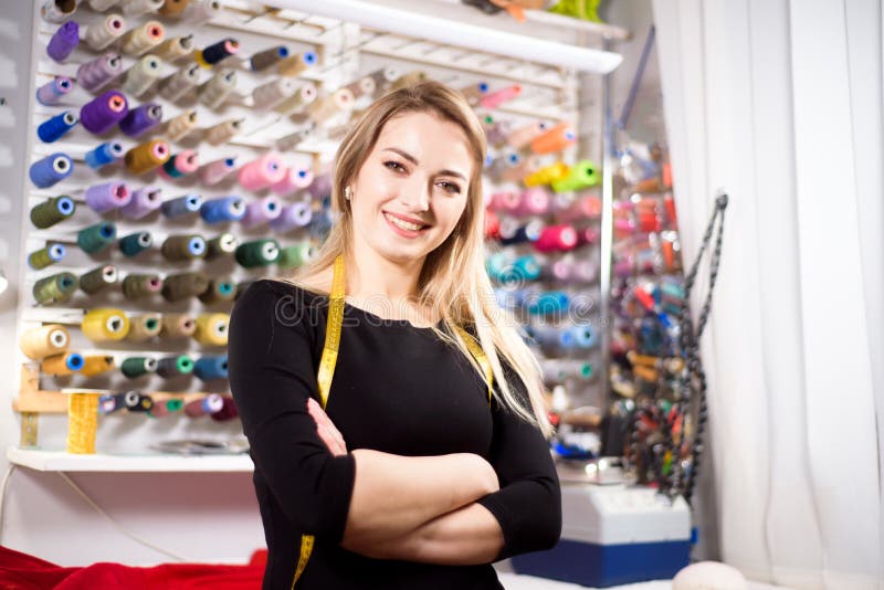 Beautiful Woman Tailor on Background of Colored Spools of Thread for ...