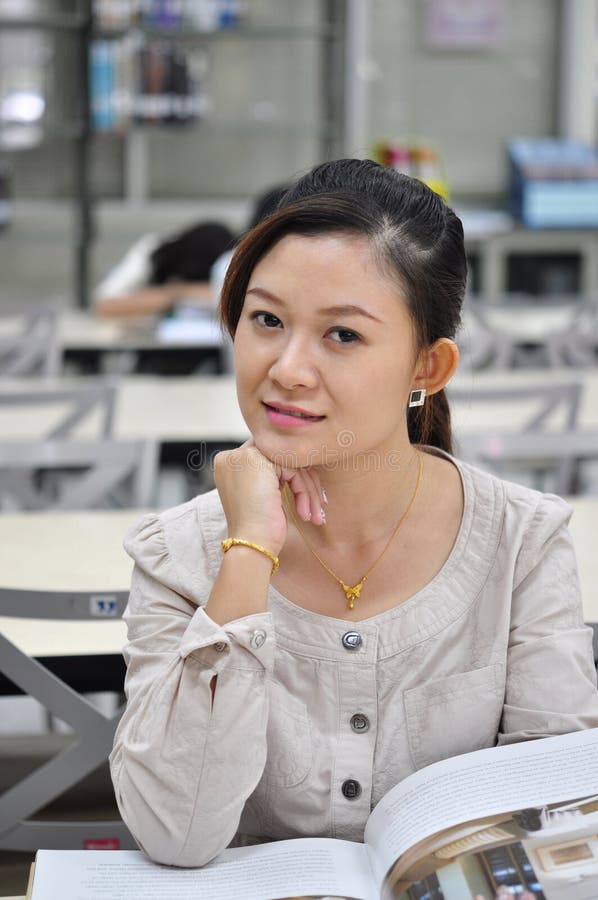 Woman in library stock photo. Image of learn, holding - 34643762