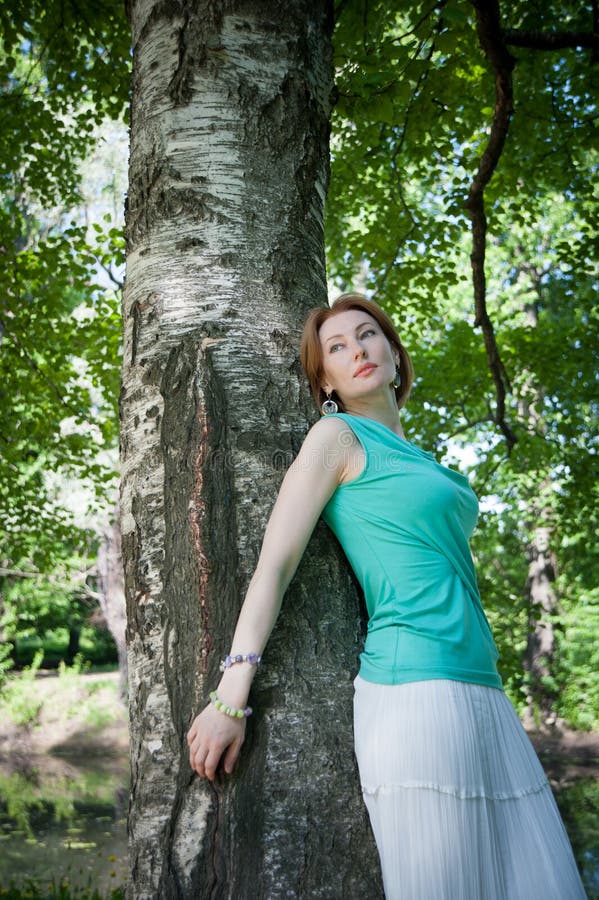 Beautiful Woman at a Tree in Summer Stock Photo - Image of saturated ...