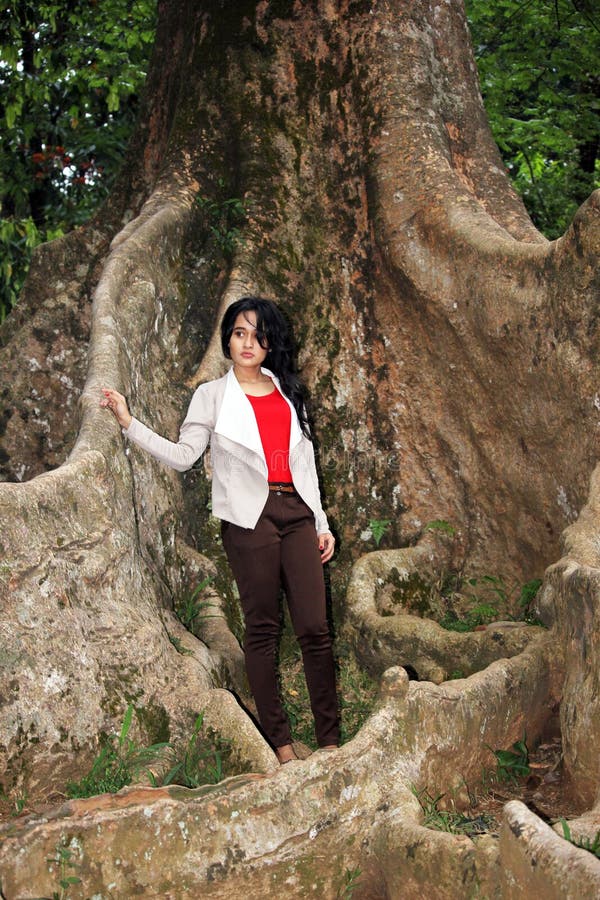 A Beautiful Woman Smiling Under Big Tree Stock Photo - Image of black ...