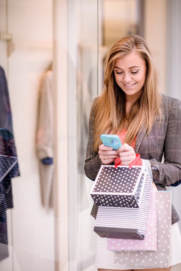 Beautiful Woman Using Her Phone while Window Shopping Stock Image ...