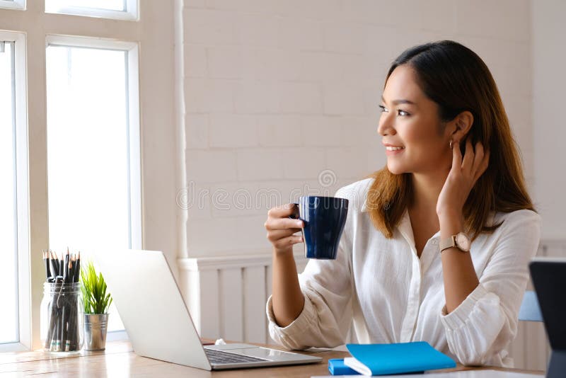 Beautiful Woman Using Laptop at Cafe while Drinking Coffee. Stock Image ...