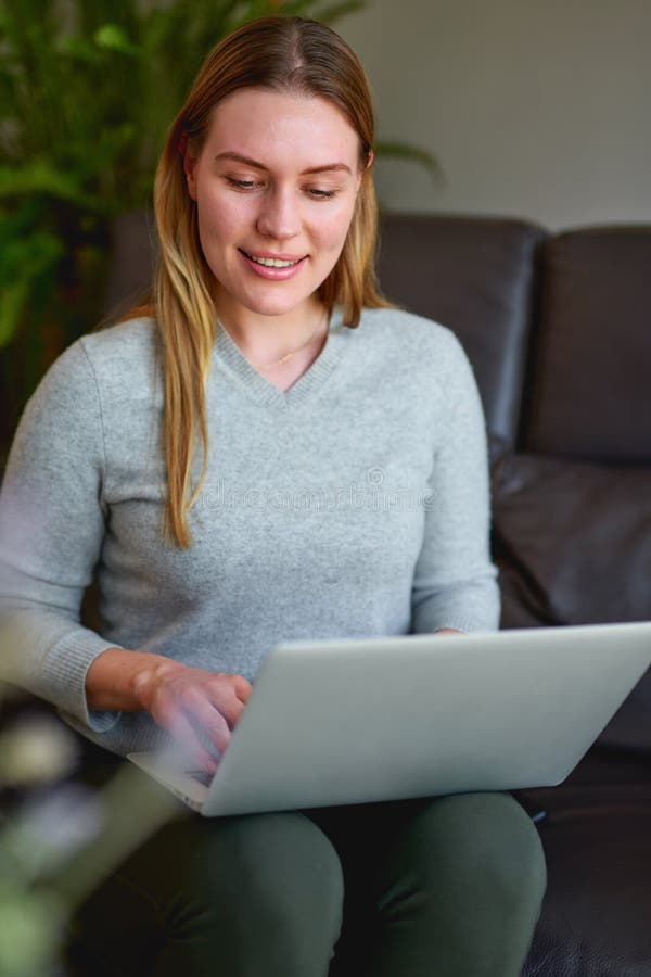 Beautiful Woman Using a Laptop Computer at Home Stock Photo - Image of ...