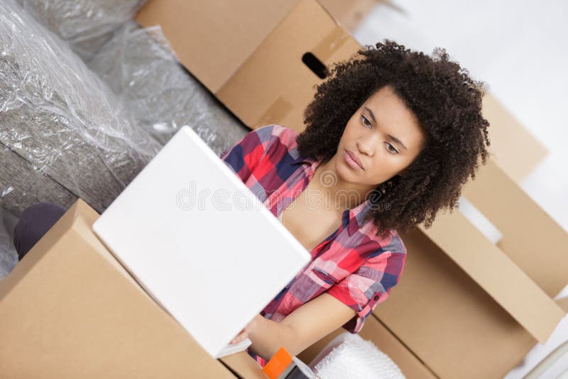 Beautiful Woman Using Laptop while Unpacking Box at Home Stock Photo ...