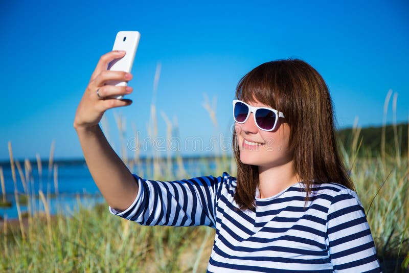 Beautiful Woman Using Smart Phone on the Beach Stock Photo - Image of ...
