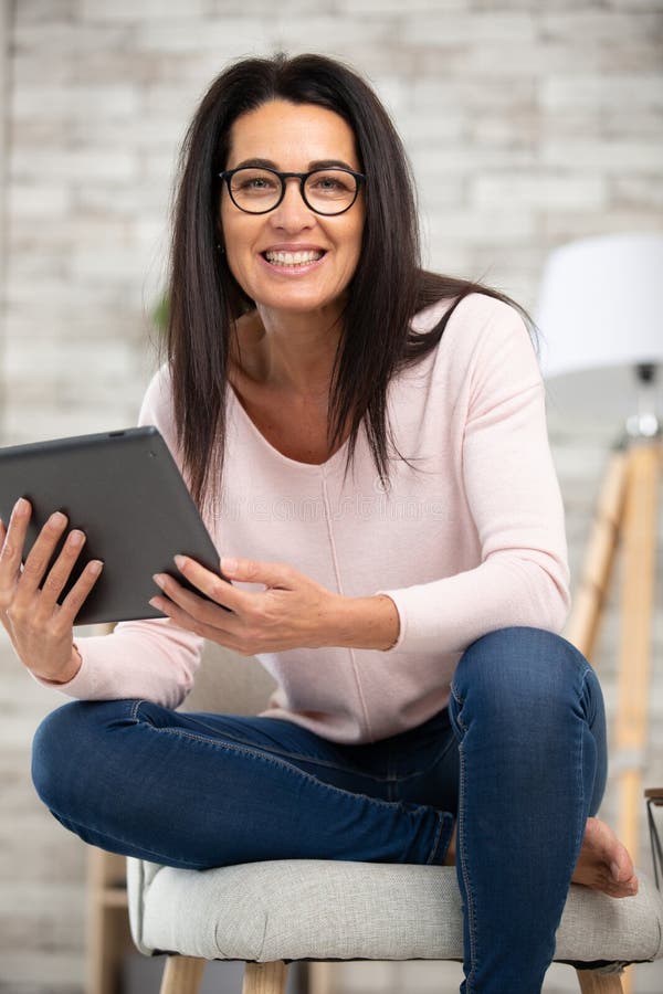 Beautiful Woman Using Tablet Sitting on Sofa Stock Photo - Image of ...