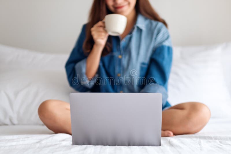 A Beautiful Woman Using and Working on Laptop Computer , Drinking ...