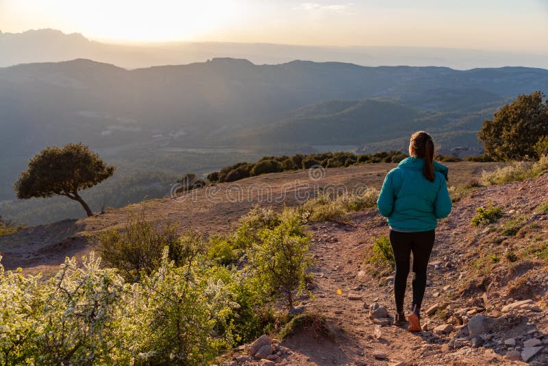 Beautiful Woman Walking on a Path during Sunset with Mountains on the ...