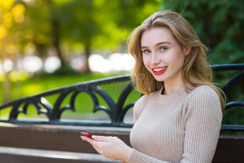 Beautiful Woman Walks Through City Streets Between Building Stock Image