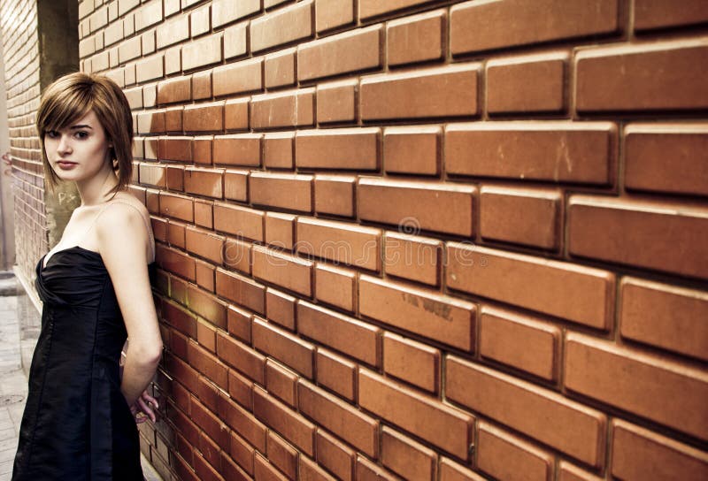 Beautiful woman on wall stock photo. Image of elegance - 5372148