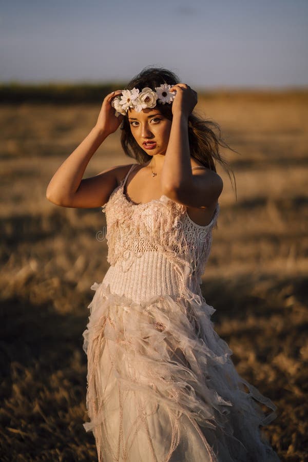 Beautiful Woman Wearing A White Dress And Holding Her White Flower