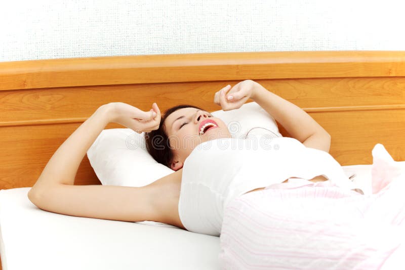 Beautiful Woman Yawning and Stretching in Bed. Stock Image - Image of ...