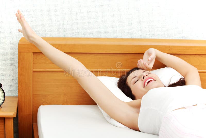 Beautiful Woman Yawning and Stretching in Bed. Stock Image - Image of ...