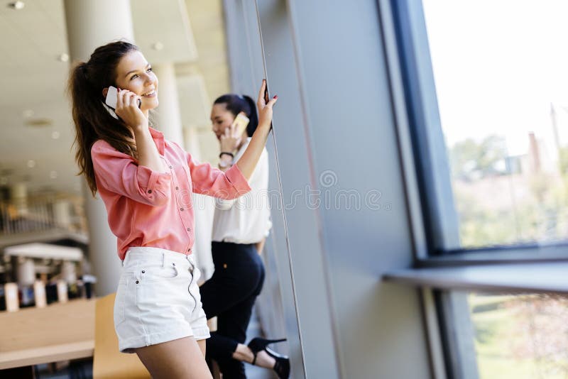 Beautiful Women Using Phones and Talkin during Break Stock Photo ...