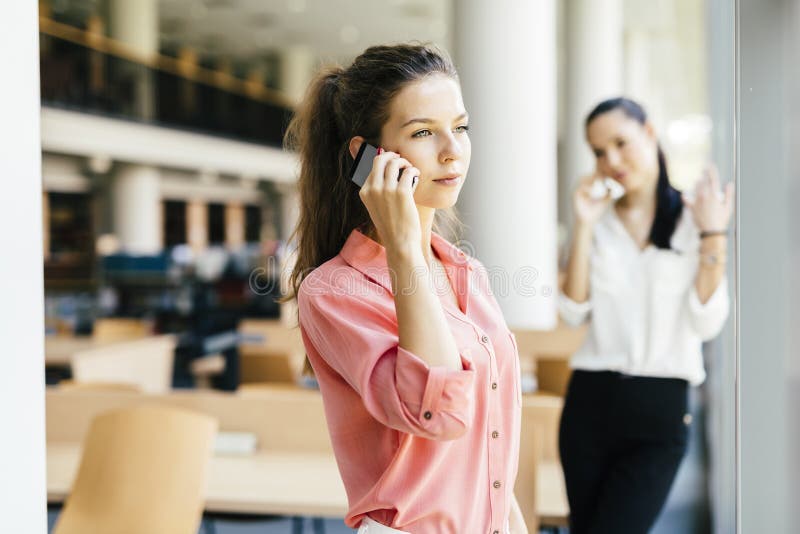 Beautiful Women Using Phones and Talkin during Break Stock Image ...
