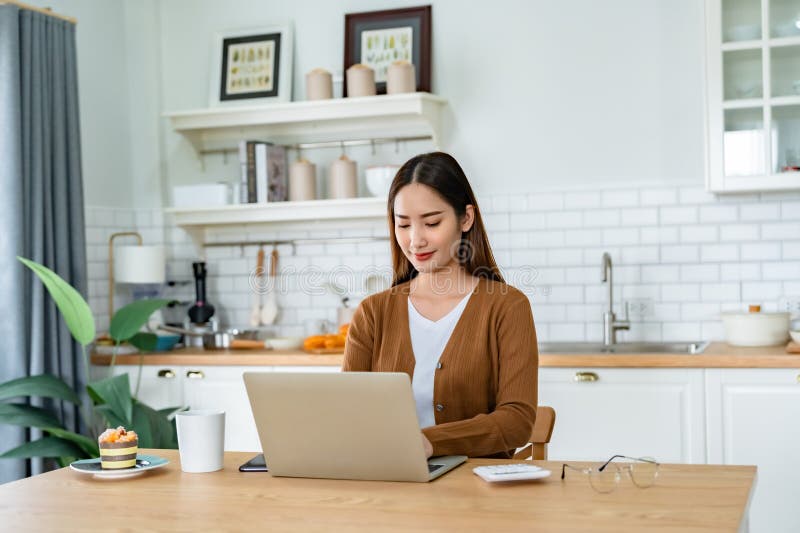 Beautiful Young Asian Woman Working with Laptop Computer in Home ...