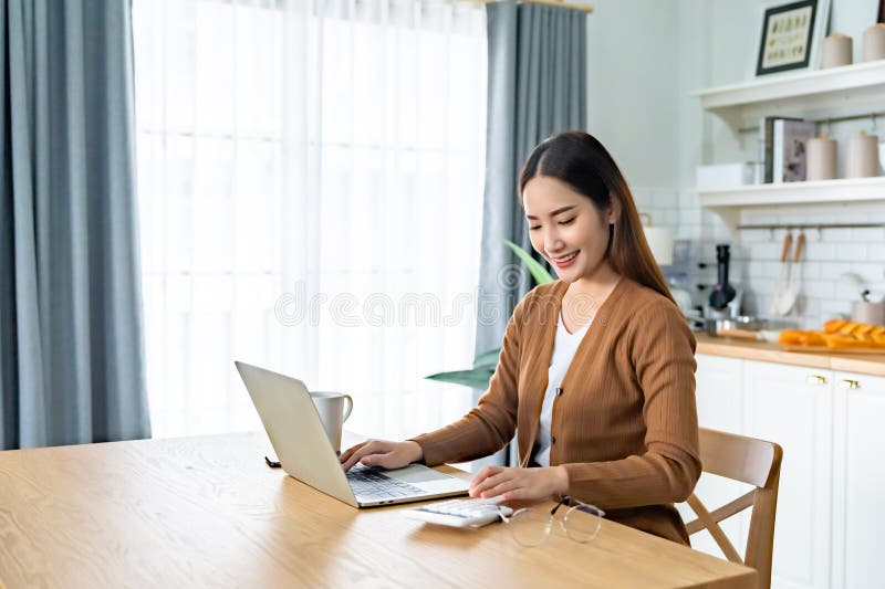 Beautiful Young Asian Woman Working with Laptop Computer in Home ...