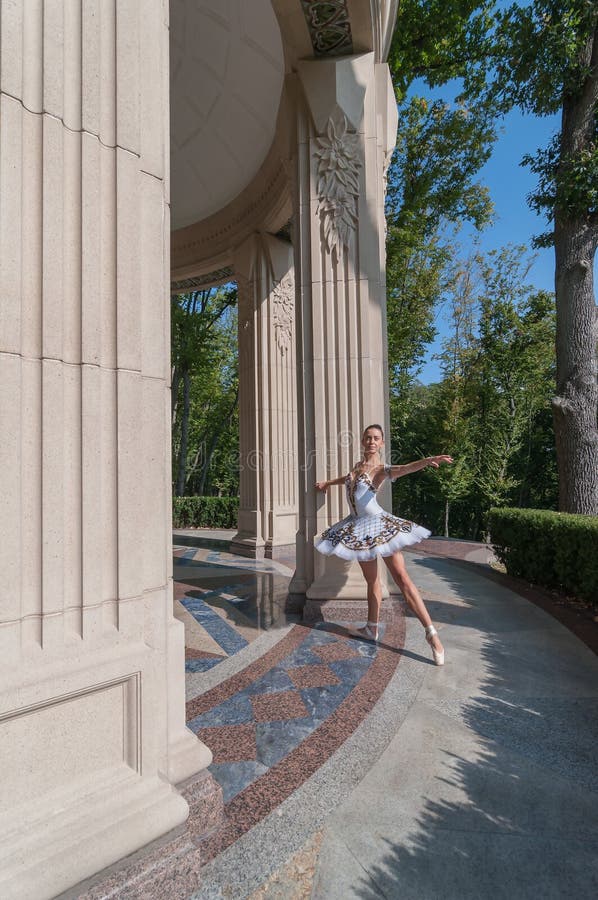 Ballerina Stands on Stairs, Standing in Pointe Position. Outdoors ...