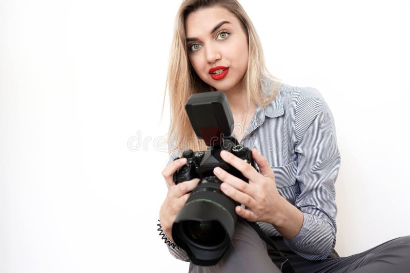 Beautiful Young Blonde with a Big Camera Looks into the Camera, Toning ...