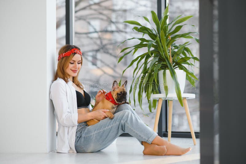 Beautiful Young Blonde Woman Playing with Her Dog at Home, Smiling ... Beautiful Young Blonde Woman Playing with Her Dog at Home, Smiling ...