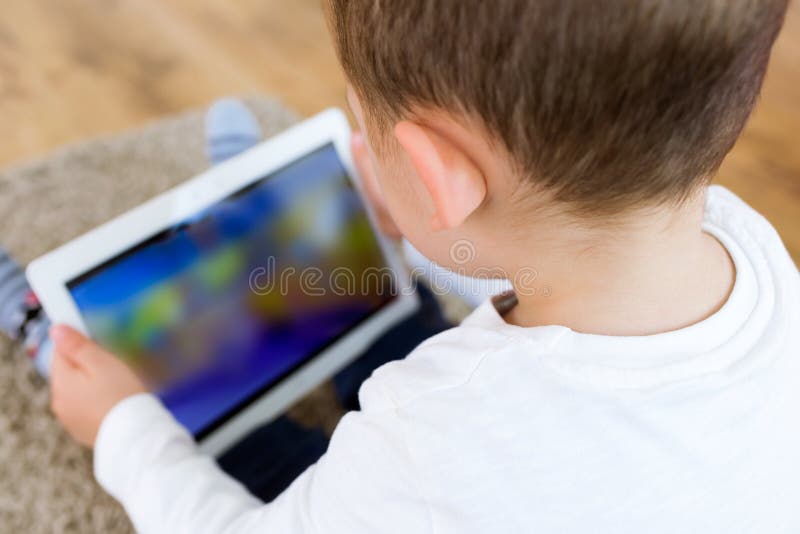 Beautiful Young Boy Using His Digital Tablet at Home. Stock Photo ...