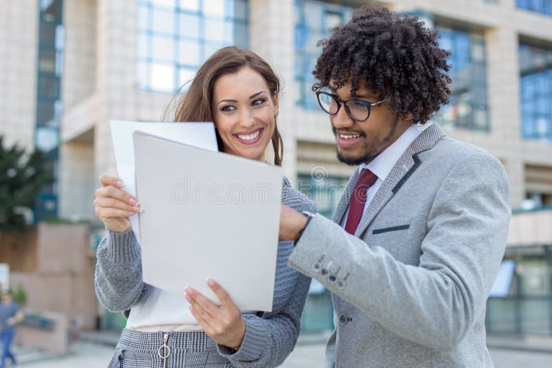 Beautiful Young Business Couple Checking Some Paperwork in Front of the ...