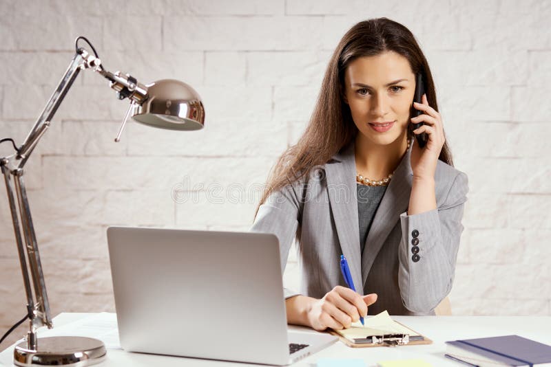 Beautiful Young Businesswoman is Calling during Work Stock Photo ...