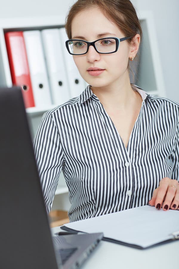 Beautiful Young Businesswoman Looking On A Laptop Screen In The Office