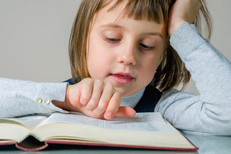 Beautiful Young Child Girl Reading a Book As Symbol of Learning ...