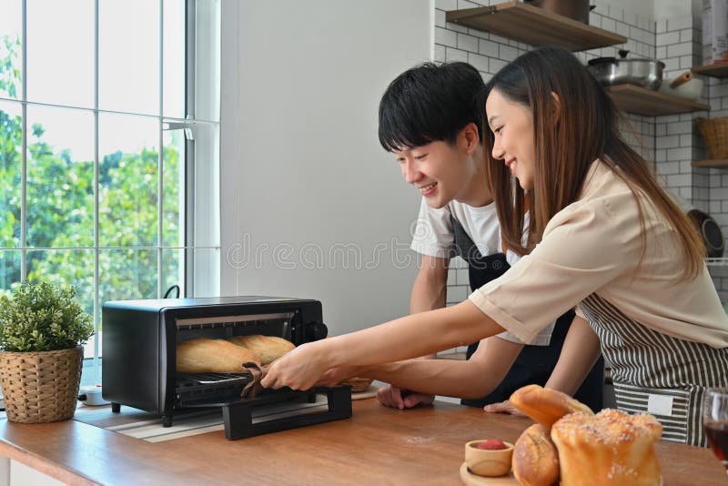 Beautiful Young Couple Baking Bread in the Oven, Preparing Breakfast in ...